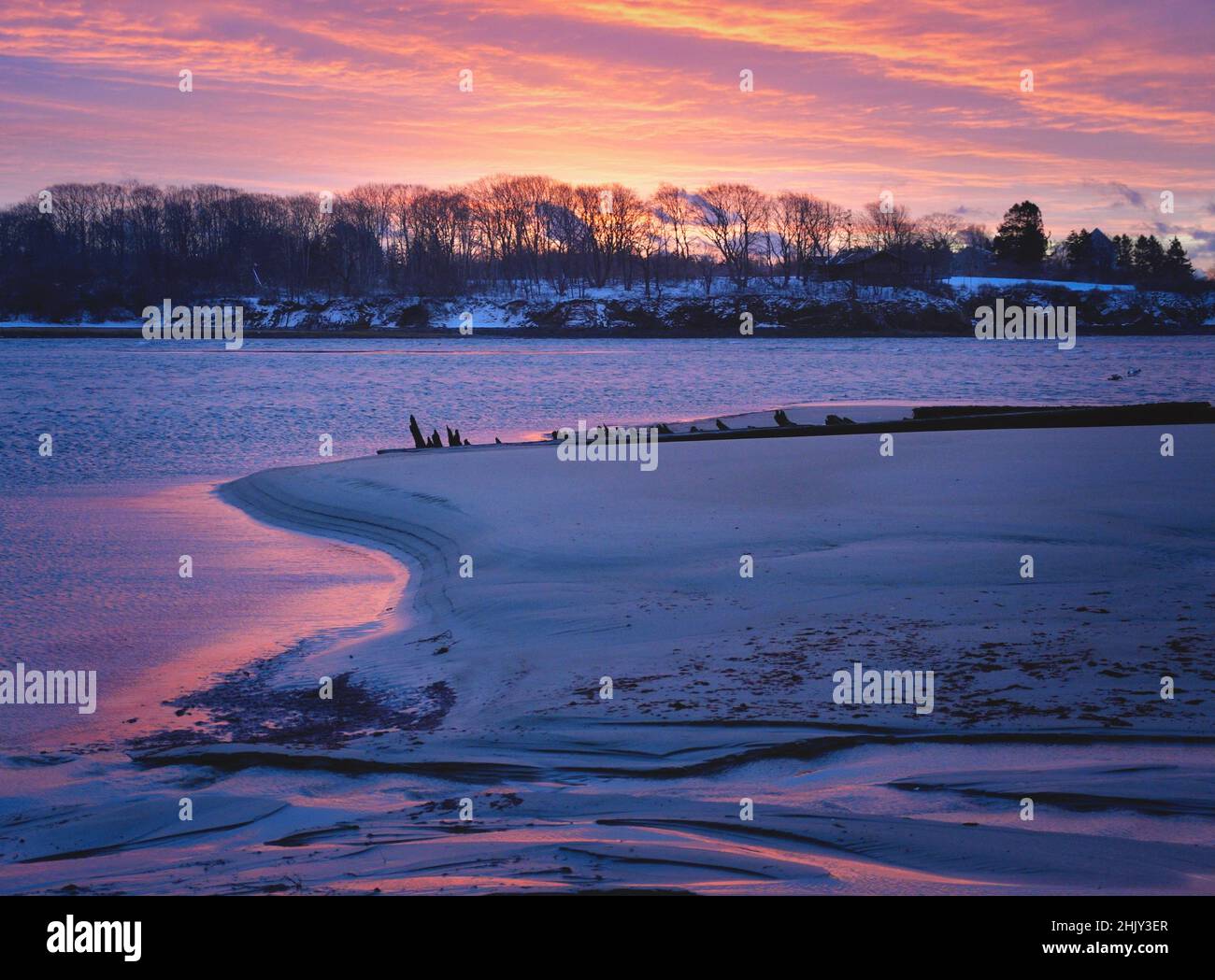 Scenic shot of a sunset across a lake with silhouettes of trees Stock ...
