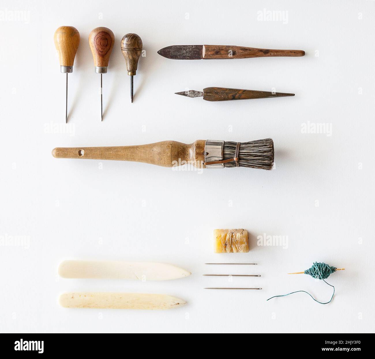 Selection of Book binders tools arranged on cream paper background ...