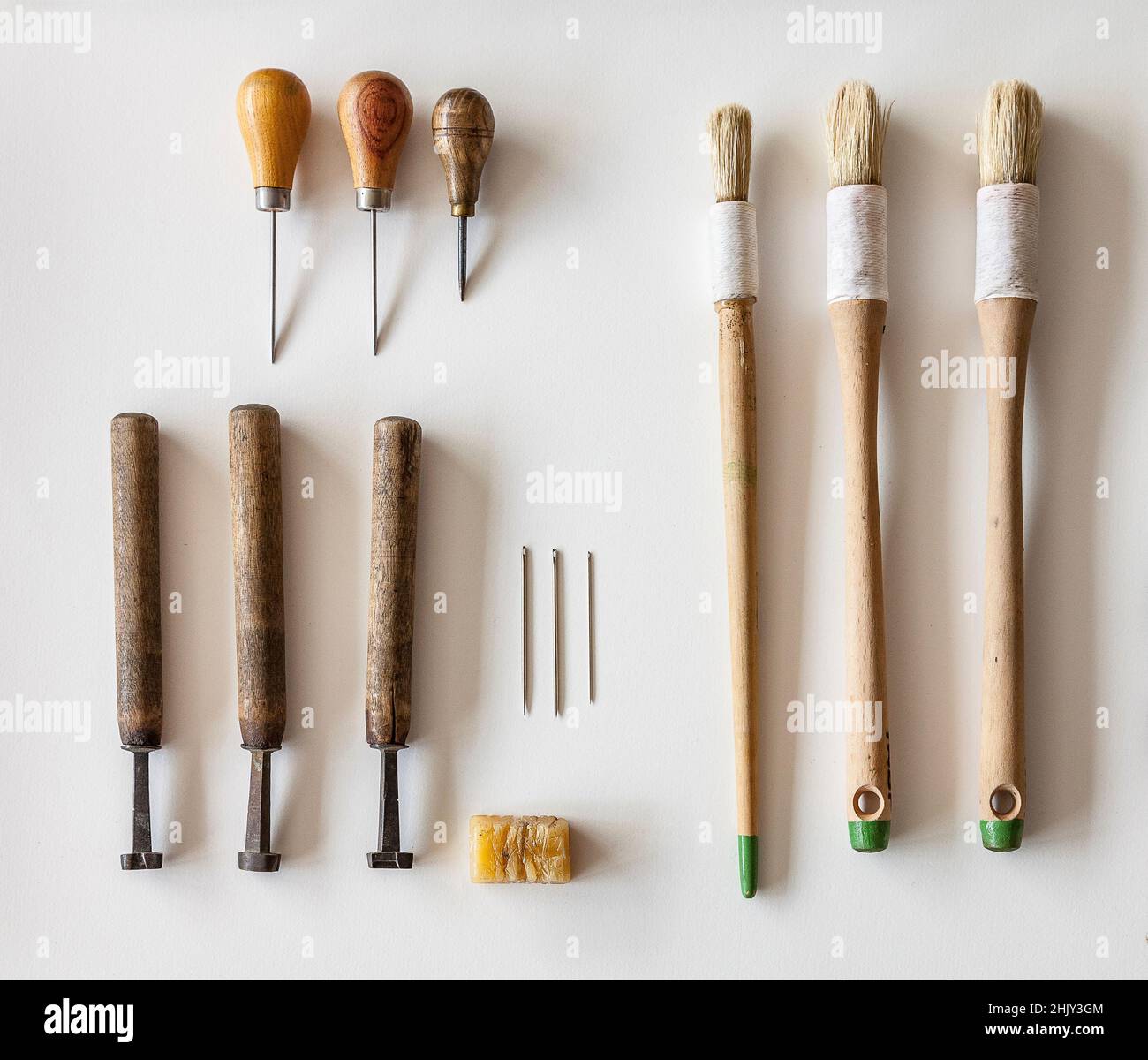 Selection of Book binders tools arranged on cream paper background ...