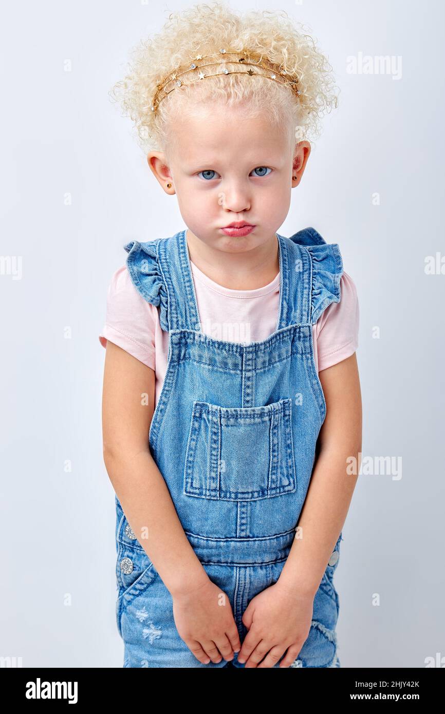 Serious pensive little kid girl looking unhappy at camera, tired upset ...