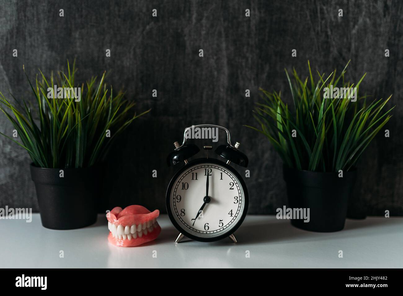 Full removable plastic prosthetic jaw and alarm clock. A denture next ...