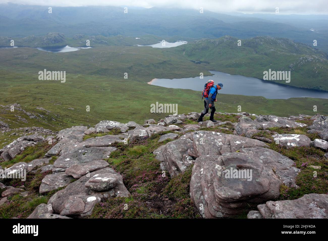 Lone Single Man Walking on Rocky Ridge Path to the Scottish Mountain ...