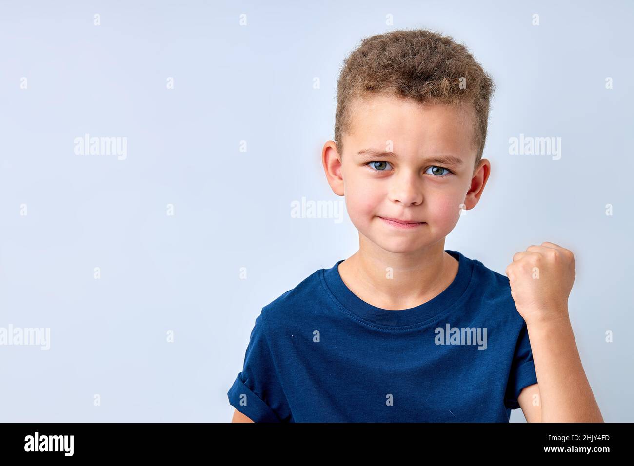 handsome boy looks angry. The child is offended, threatens, shows a ...