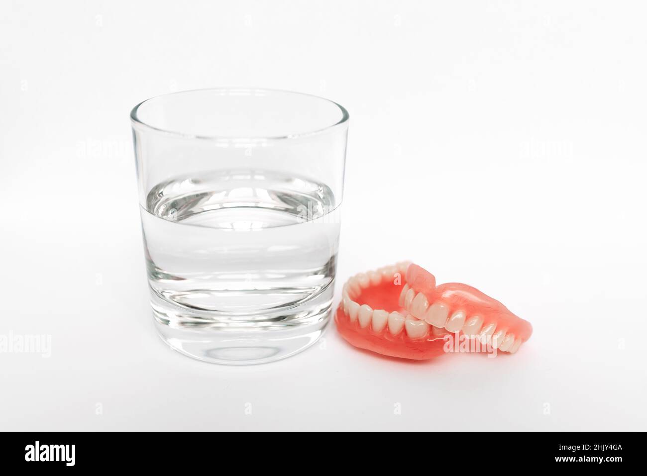 Full removable plastic denture of the jaws. Set of dentures on a white ...