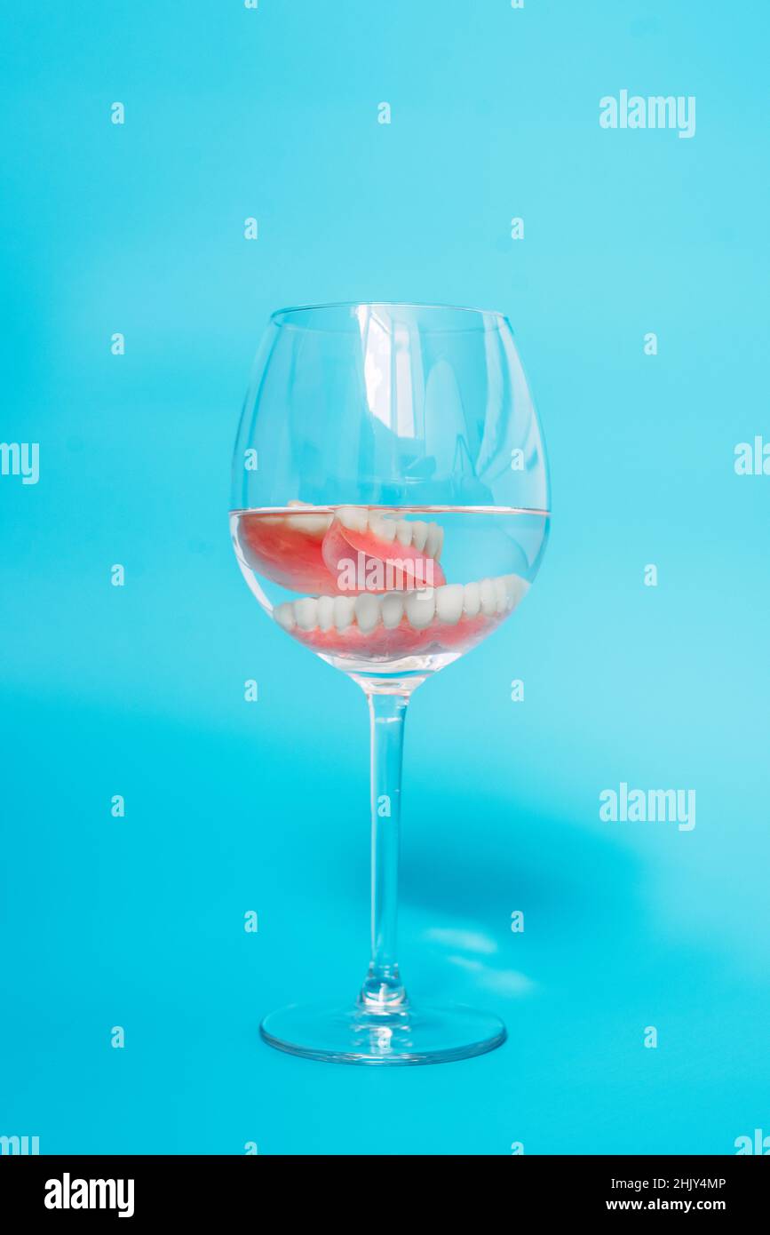 Prosthesis in a glass with a solution. Dental prosthesis care. Full ...