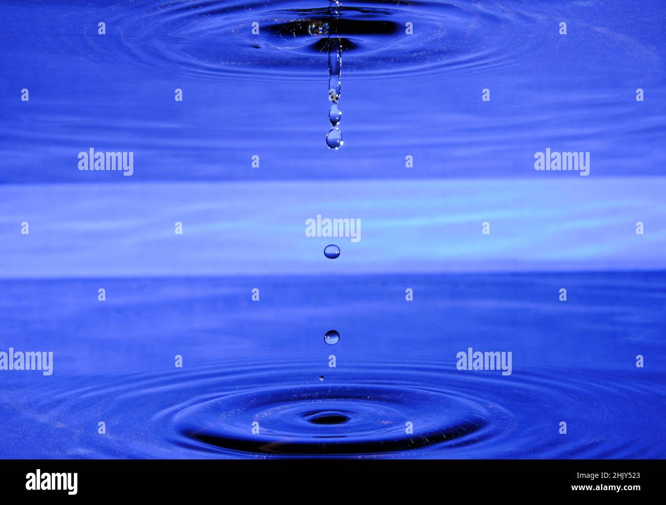 Water droplets dripping from above and below. Water splashes after a ...
