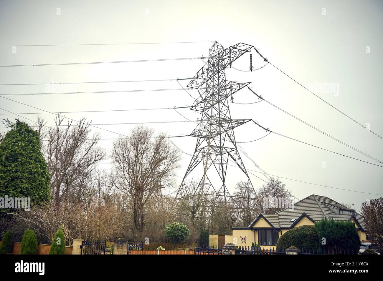 Electricity pylon and power lines in residential area Stock Photo - Alamy
