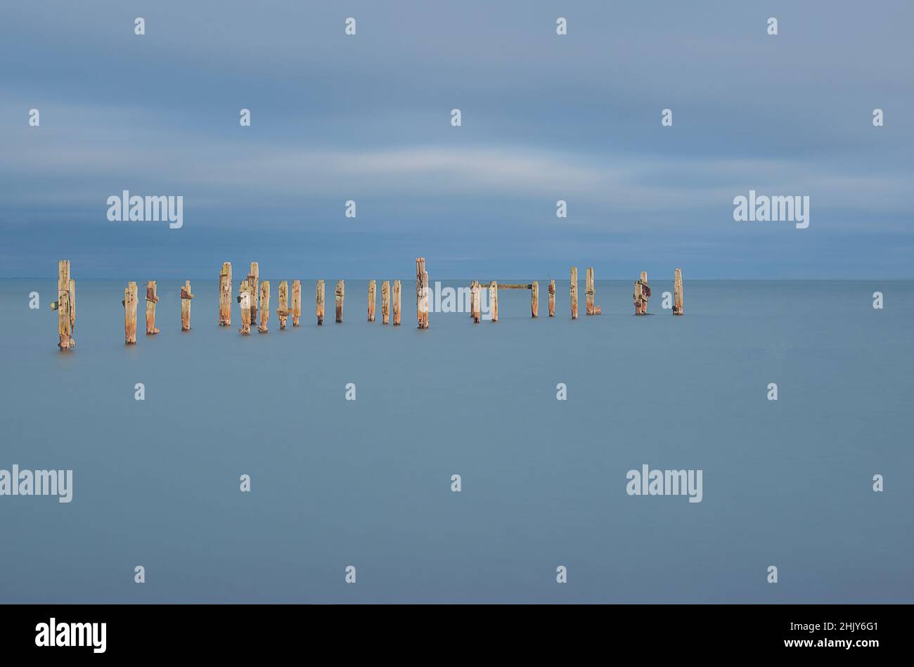 A minimalism image of the Swanage Dorset old pier posts standing in the ...