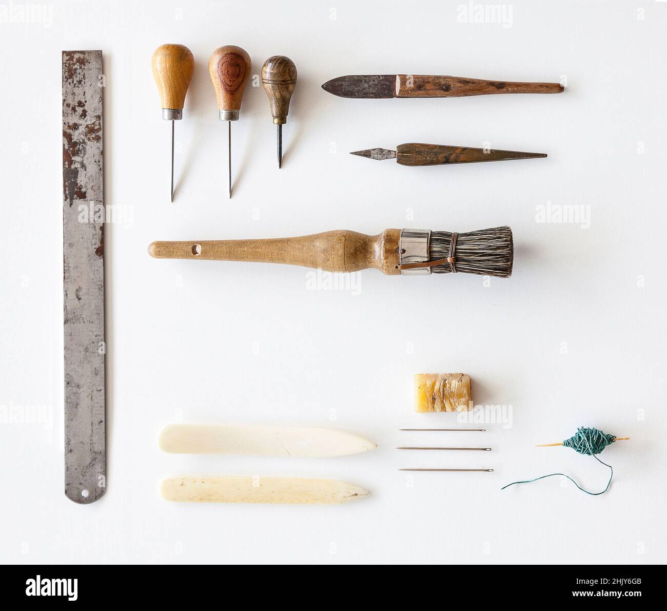 Selection of Book binders tools arranged on cream paper background ...