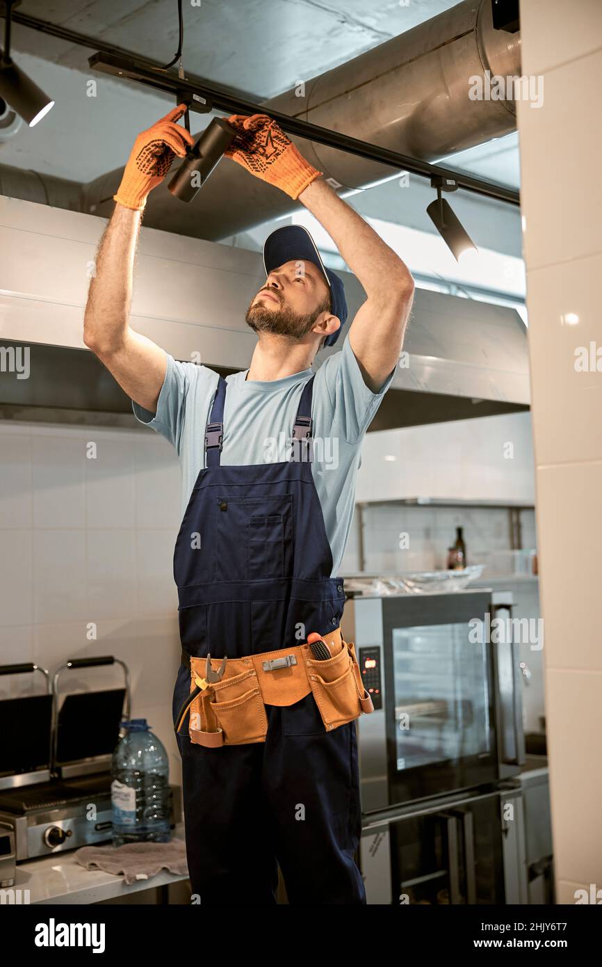 Male worker fixing ceiling hi-res stock photography and images - Alamy