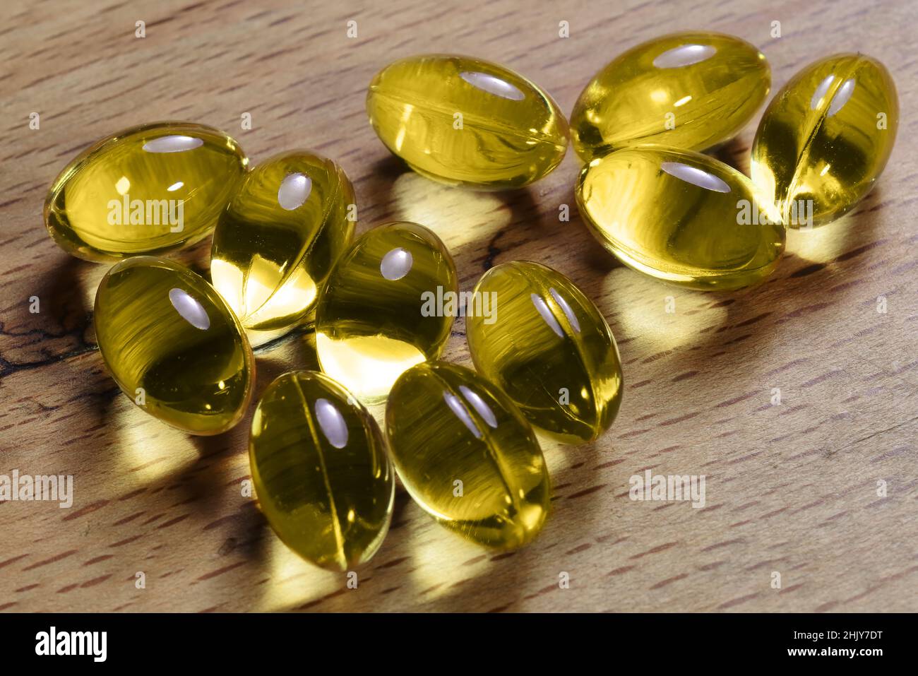 Fish fat cod liver oil omega gel capsules on wooden background Stock ...