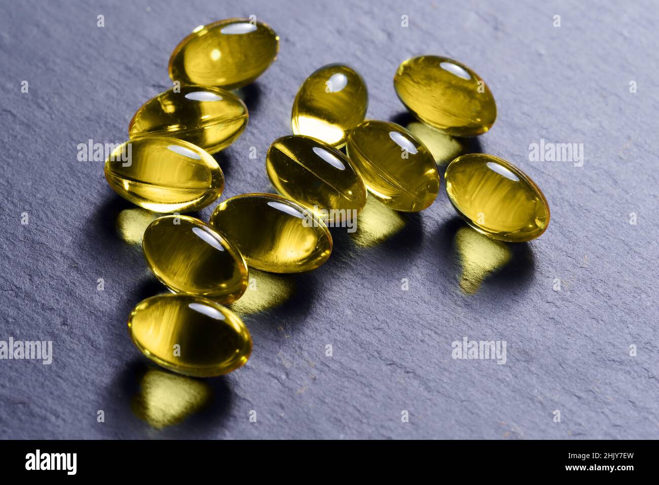 Fish fat cod liver oil omega gel capsules on stone background Stock ...