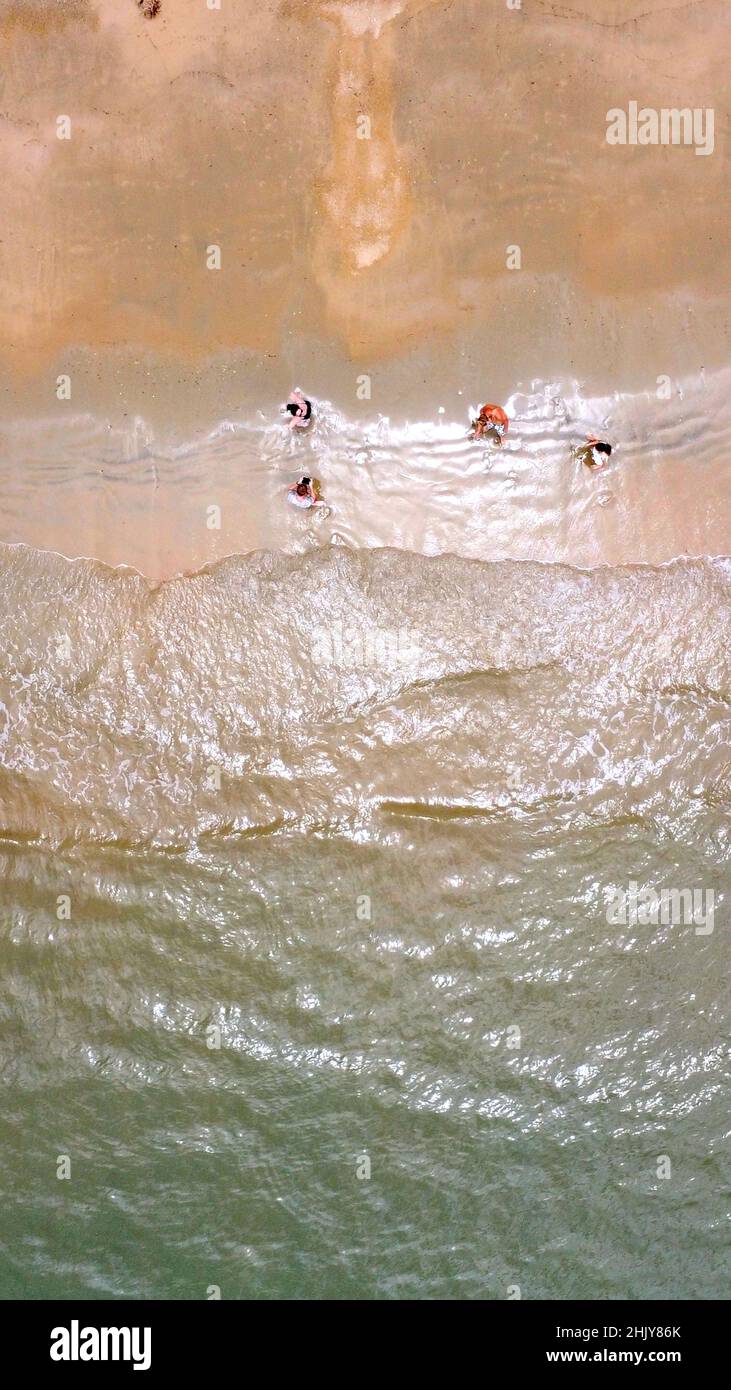 People at the waters edge on Ellis beach Stock Photo - Alamy