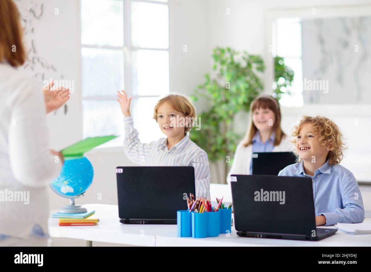 School children with laptop computer. Video conference chat with ...