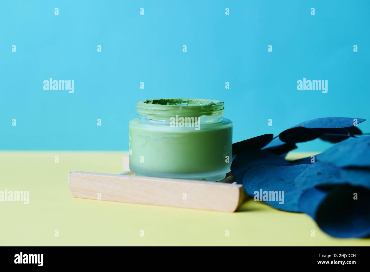 bubble clay mask in container on color background Stock Photo - Alamy