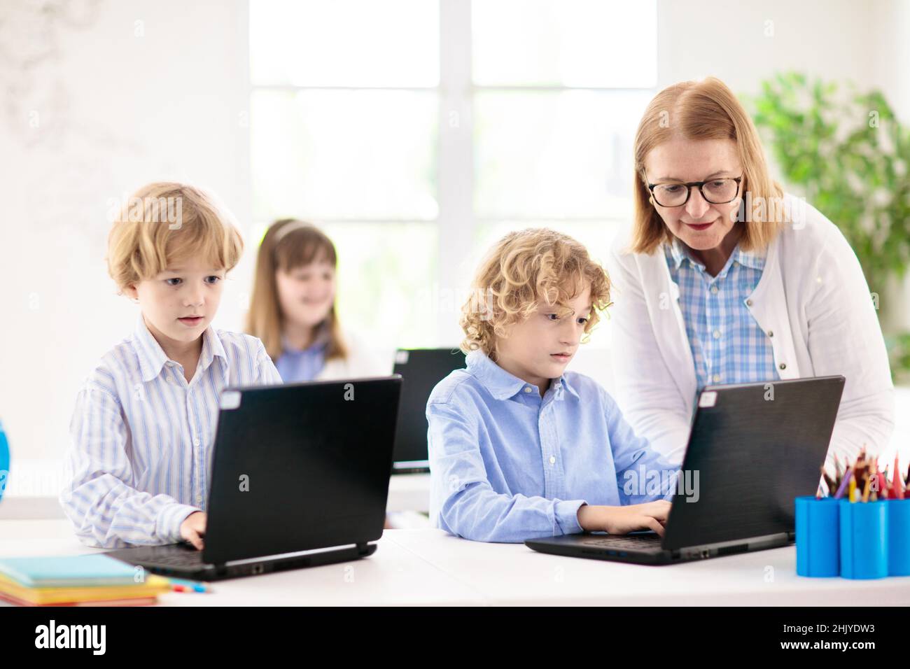 School children with laptop computer. Video conference chat with ...