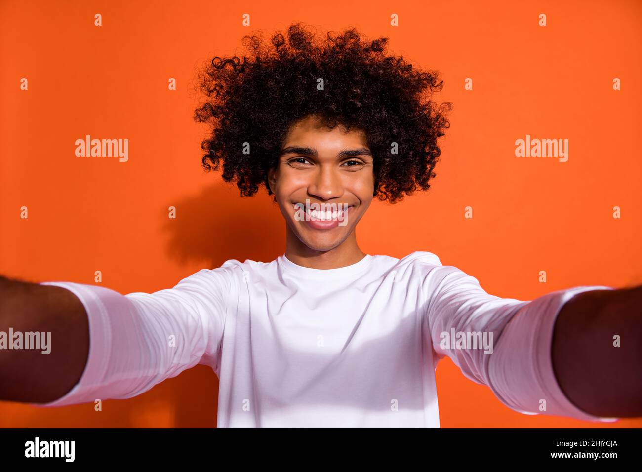Photo of funny charming guy dressed white shirt smiling tacking selfie ...