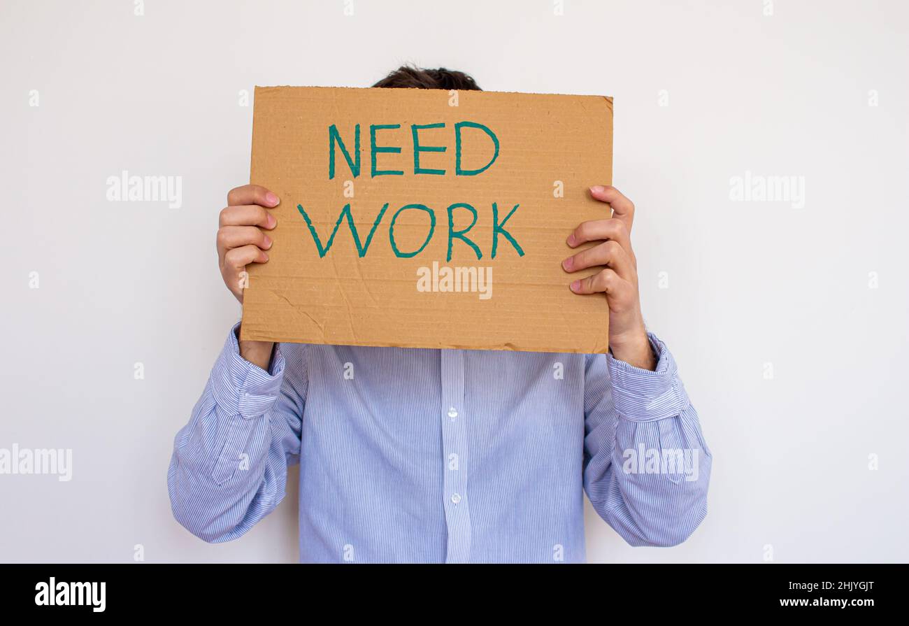 Unemployed man holding sign board with inscription NEED WORK. Concept ...