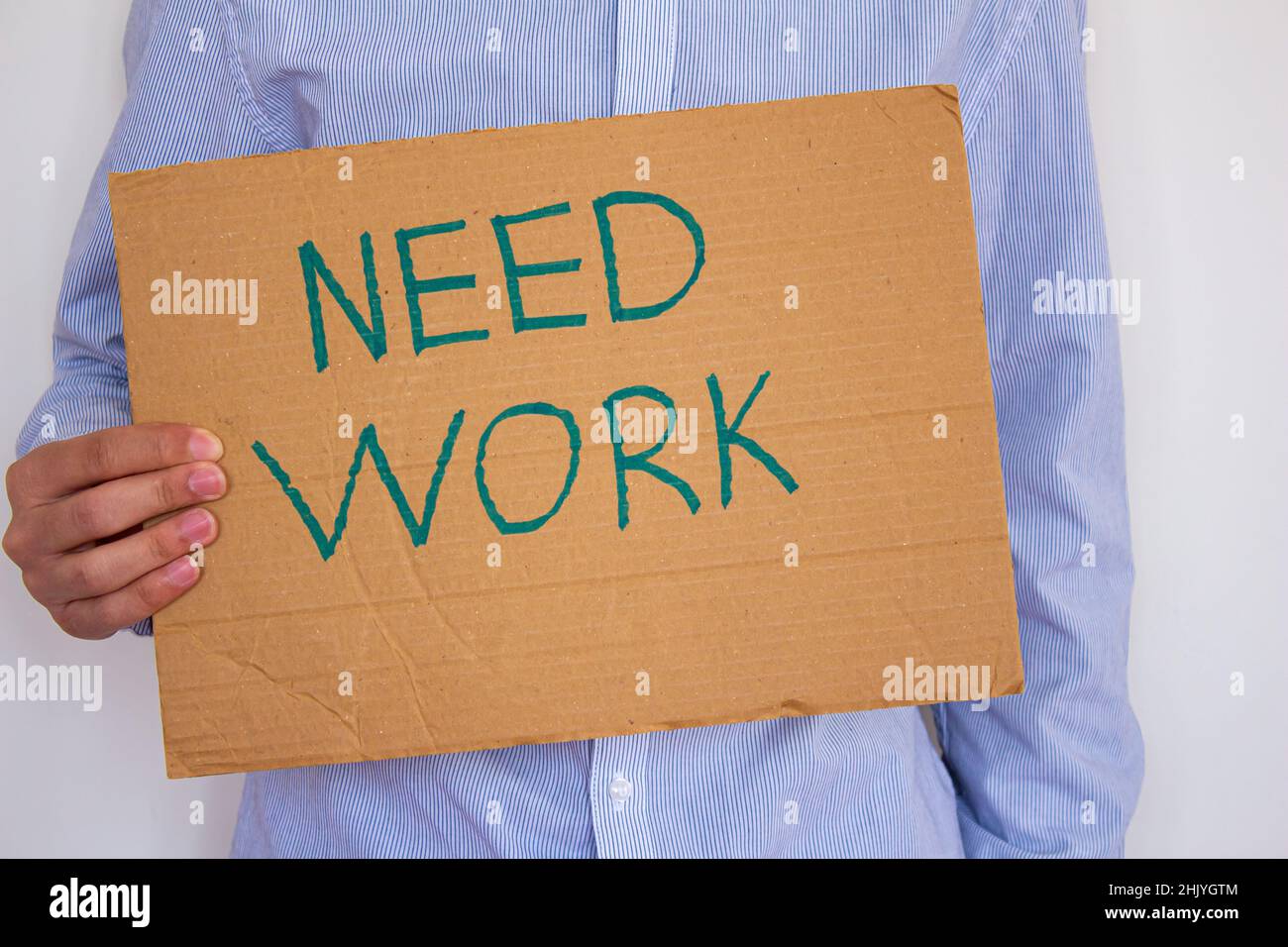 Unemployed man holding sign board with inscription NEED WORK. Concept ...