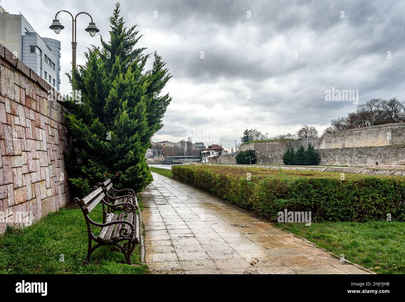 Pedestrian promenade - Paved Walkway with benches along the bank of ...