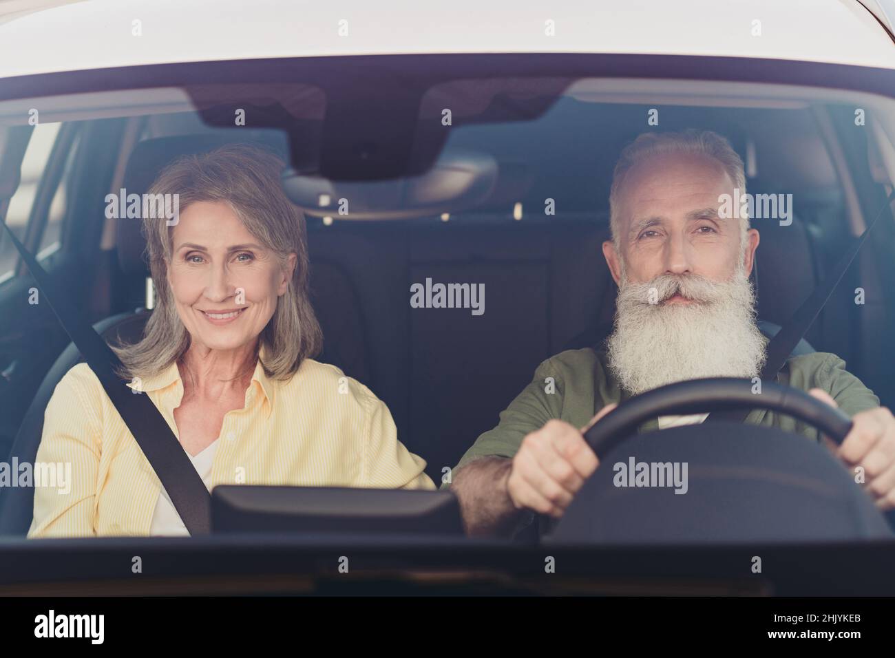 Photo of beautiful positive retired couple wear casual clothes driving ...