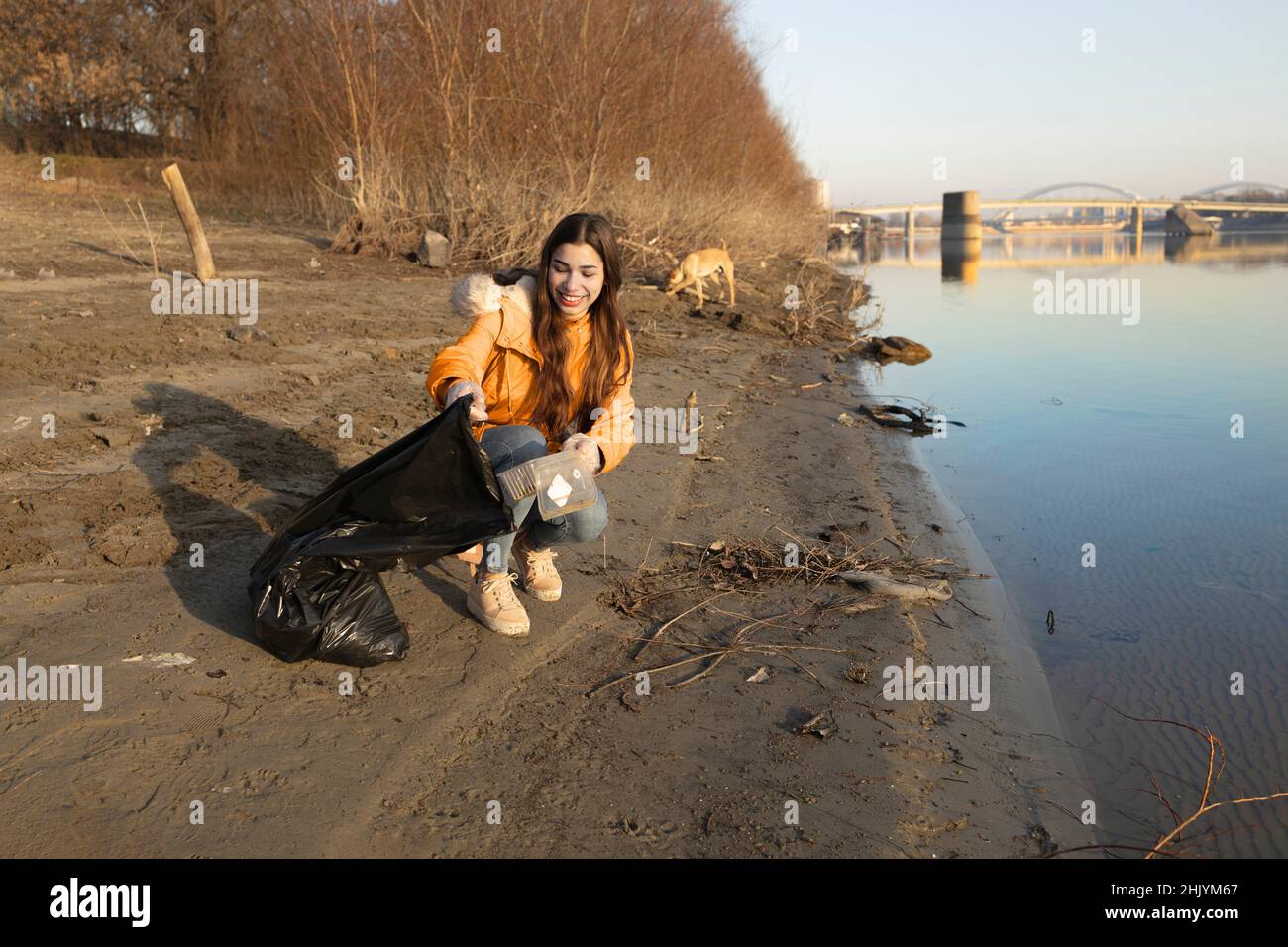 Young conservationist cleaning up the river in her city Stock Photo - Alamy