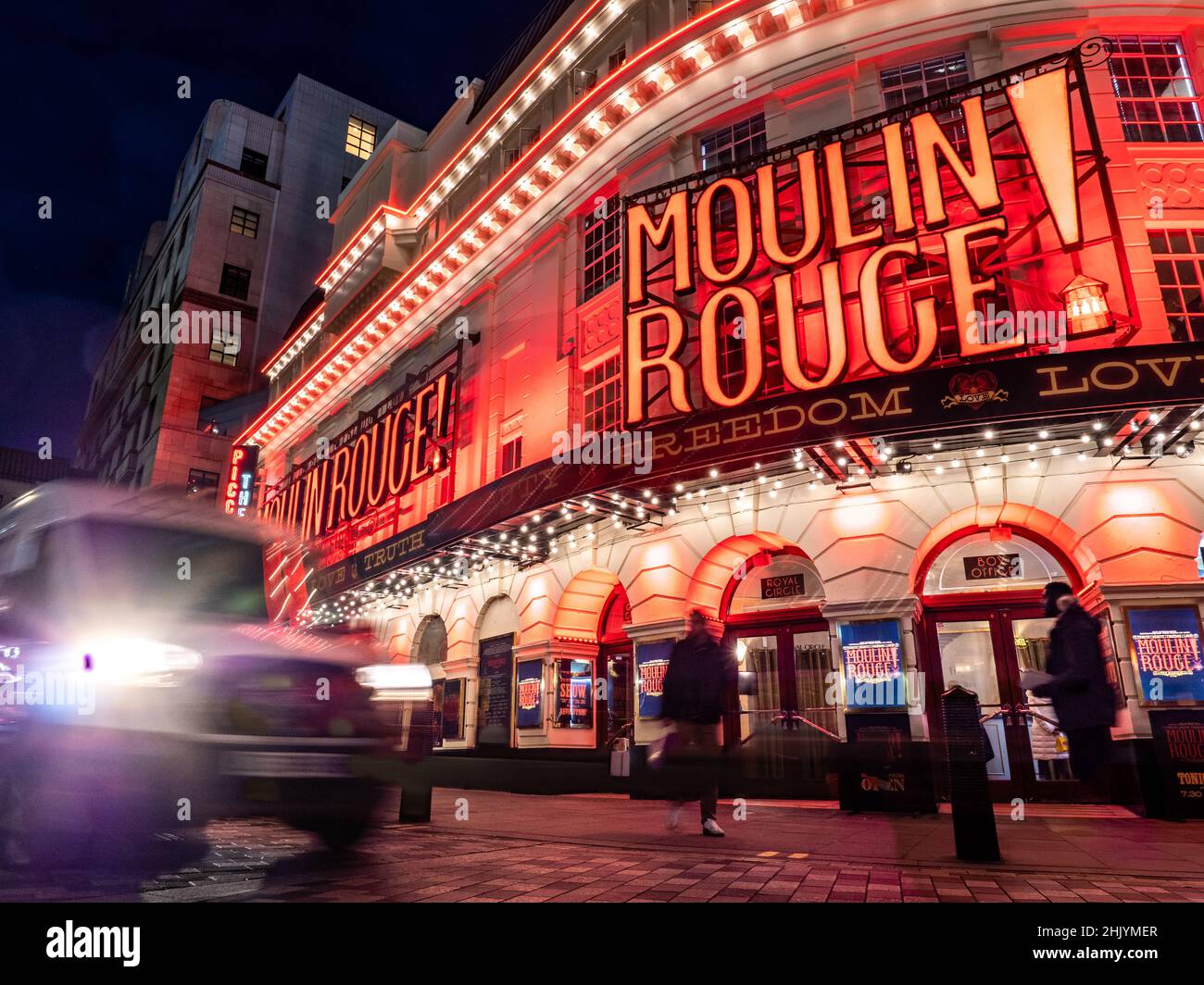 Moulin Rouge. Night view of the brightly illuminated façade to the ...