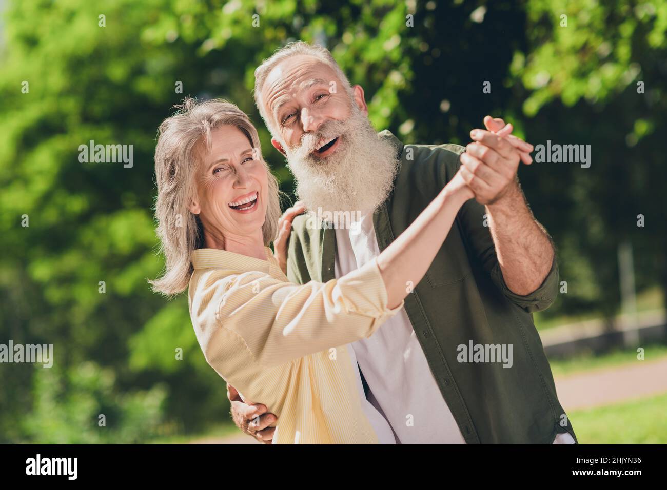 Photo of carefree funny retired couple in love dance party wear casual ...