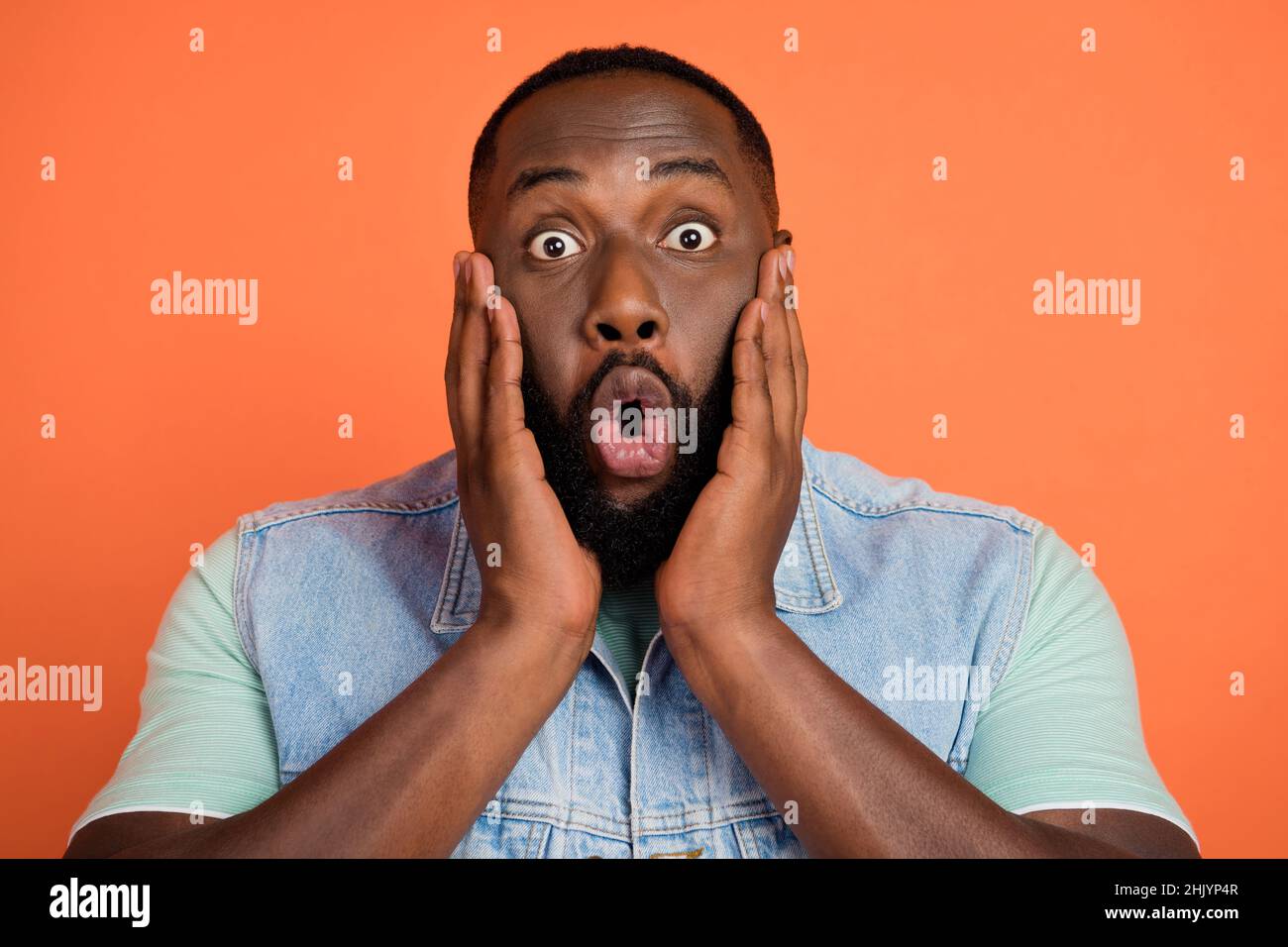 Photo of impressed pretty guy dressed jeans waistcoat big eyes arms ...