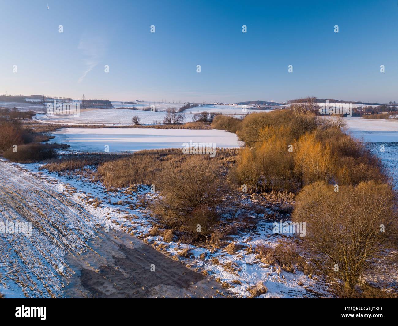 Aerial bird view of beautiful winter landscape with frozen pond covered ...