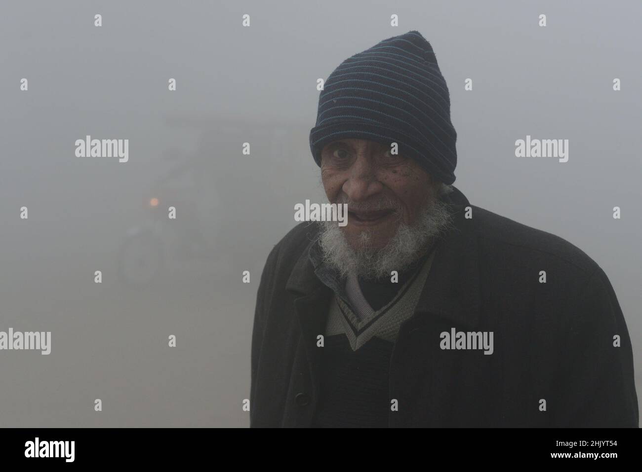 Pakistani citizens and students on their way during a cold and dense ...