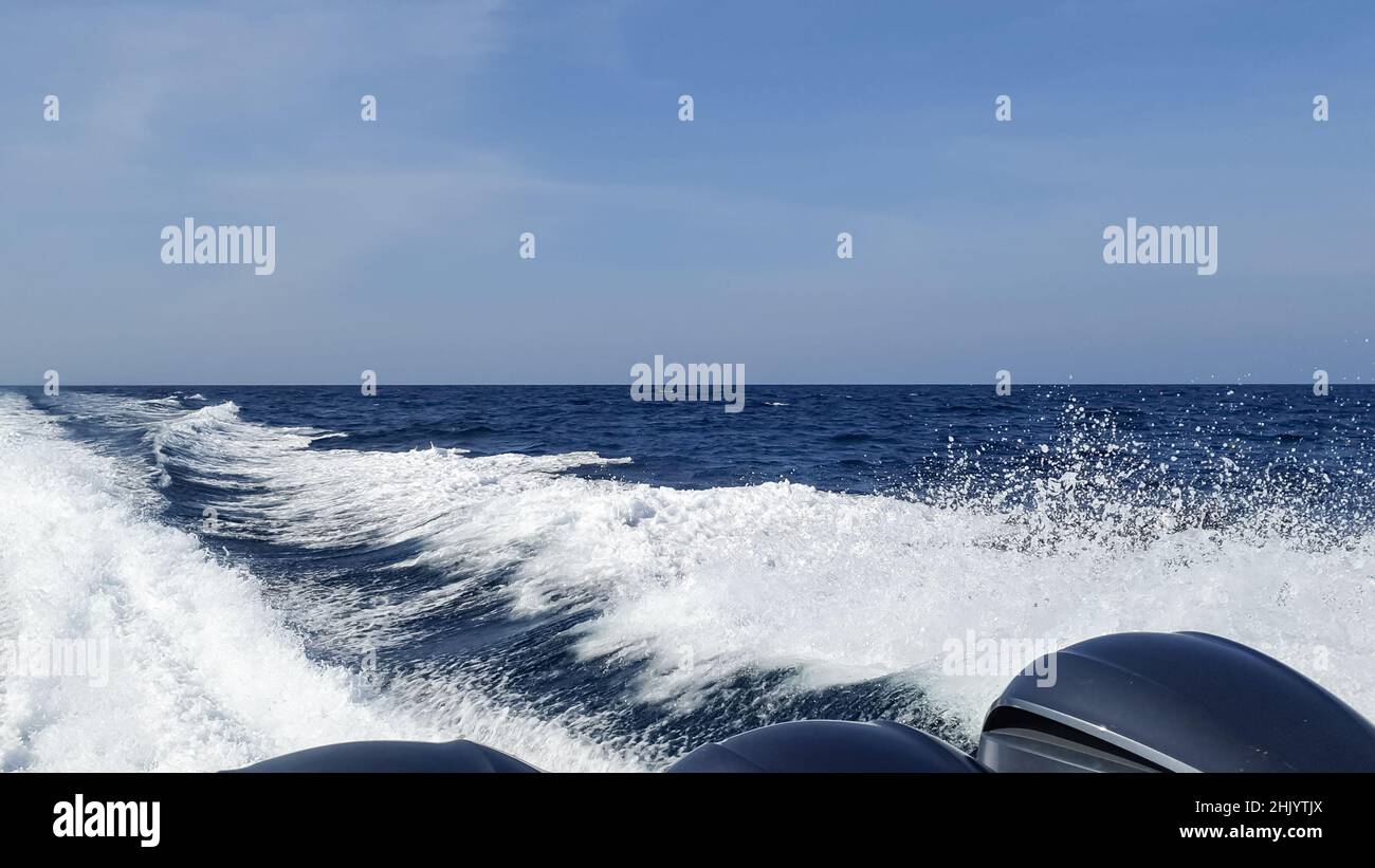 Sea wake trail behind a speed boat with waves, foam, bubbles on the ...