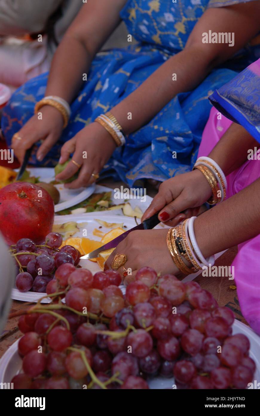 Rome, Italy 19/10/2007: Indian women prepare fruits during Durga Puja ...
