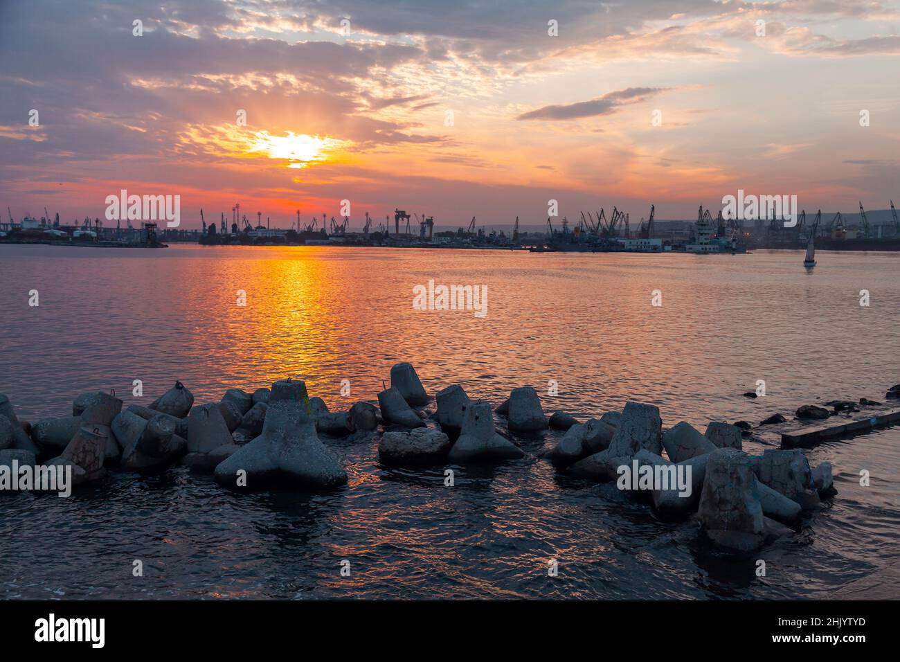 Old breakwater structure on a susnset. Varna port landscape under ...