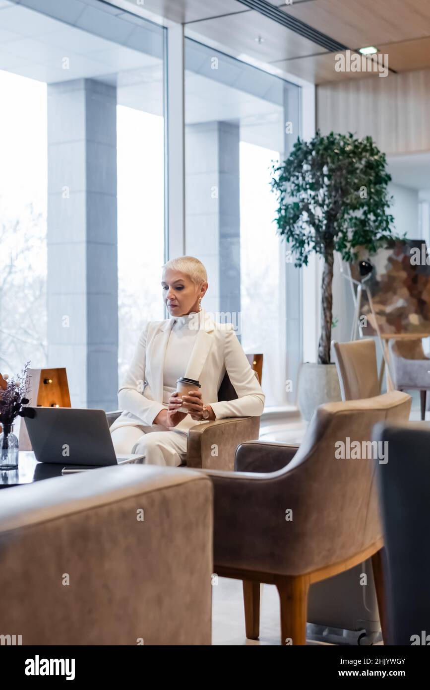Laptop coffee cup lounge hotel hi-res stock photography and images - Alamy
