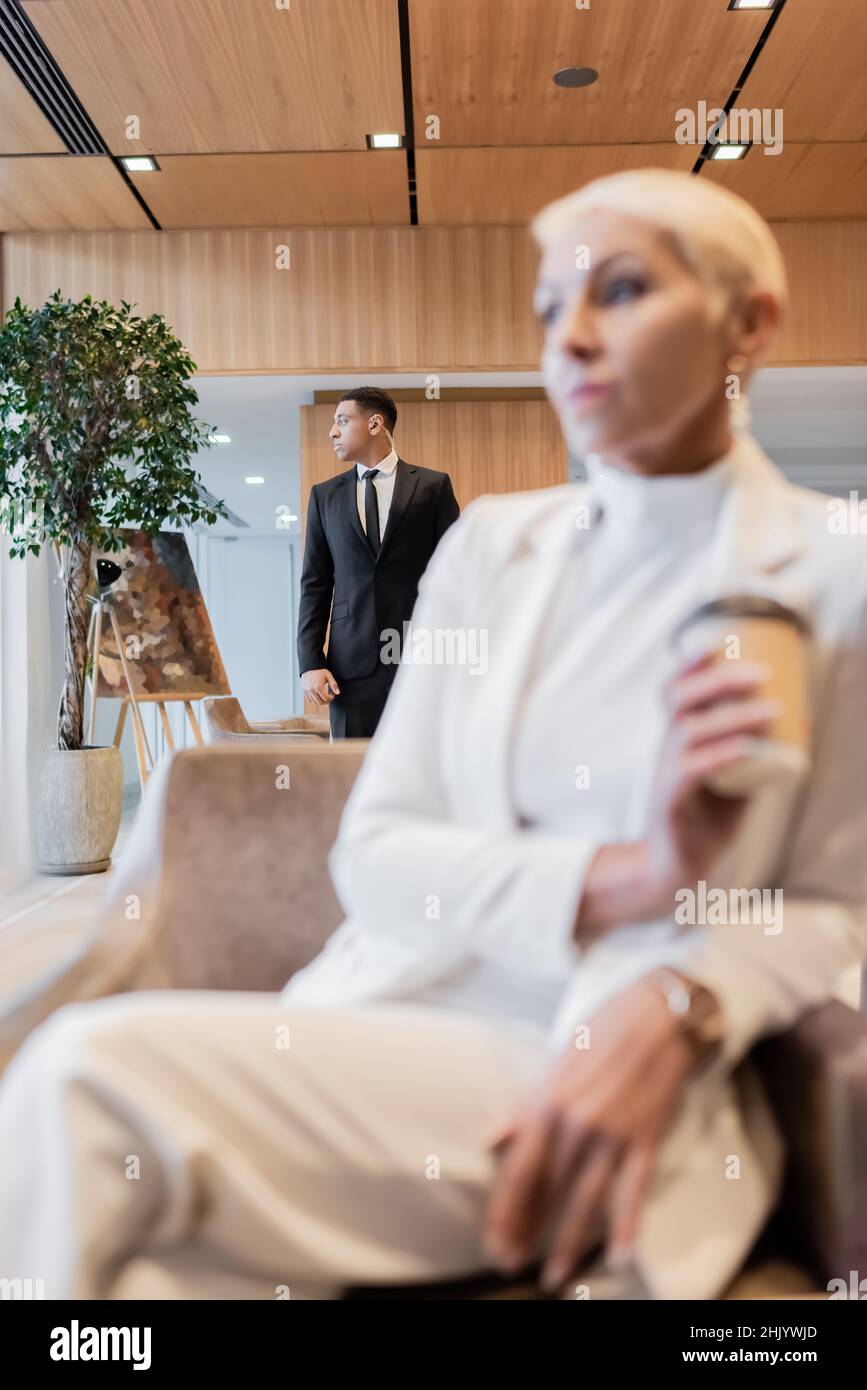 selective focus of african american bodyguard near senior business lady ...