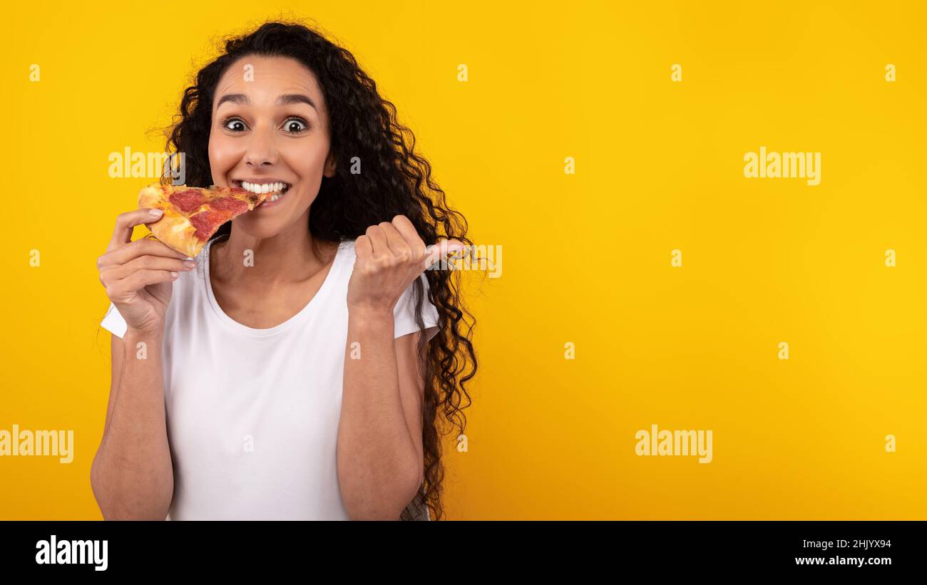 Young woman eating pizza model hi-res stock photography and images - Alamy