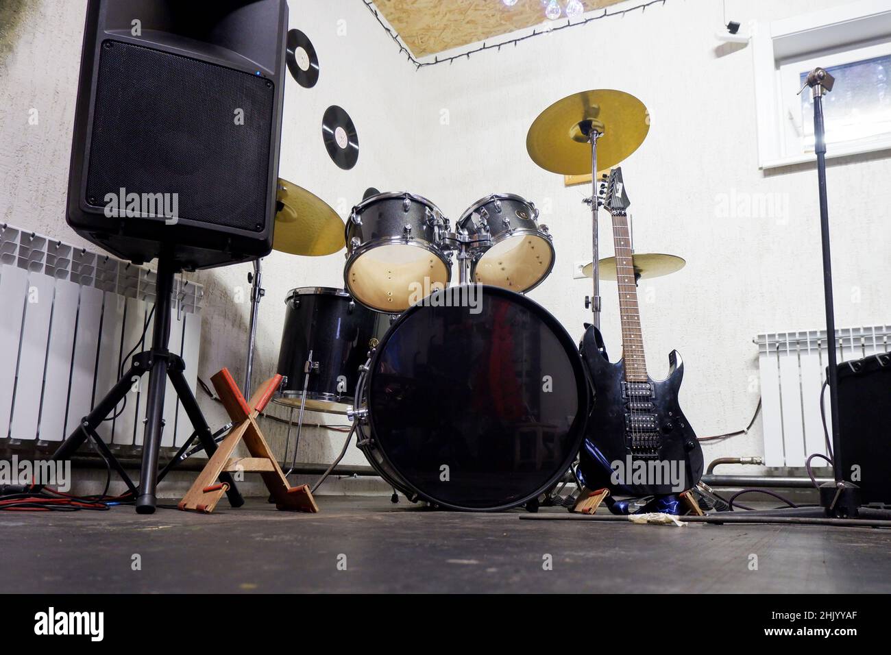 musical instruments - drums and electric guitar are in the corner in ...