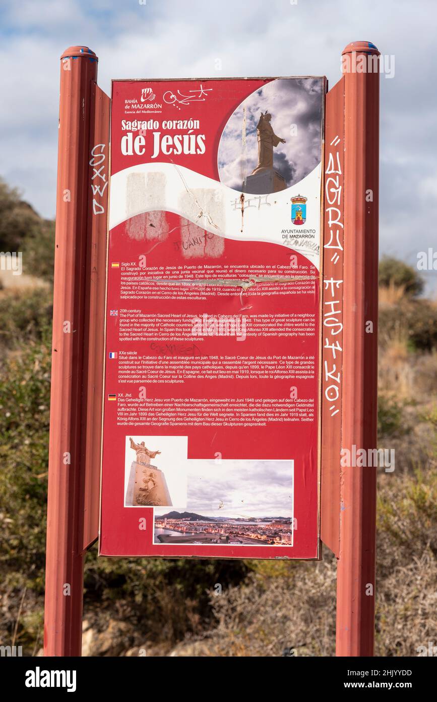 Graffitied sign for Corazon de Jesus religious statue above Puerto de ...