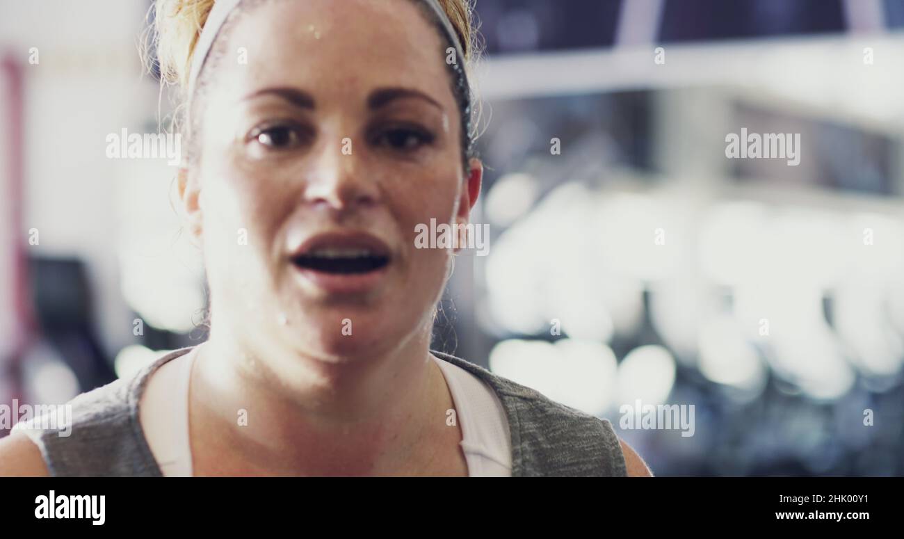 Gear up of an exhausting workout. 4k footage of a woman looking ...