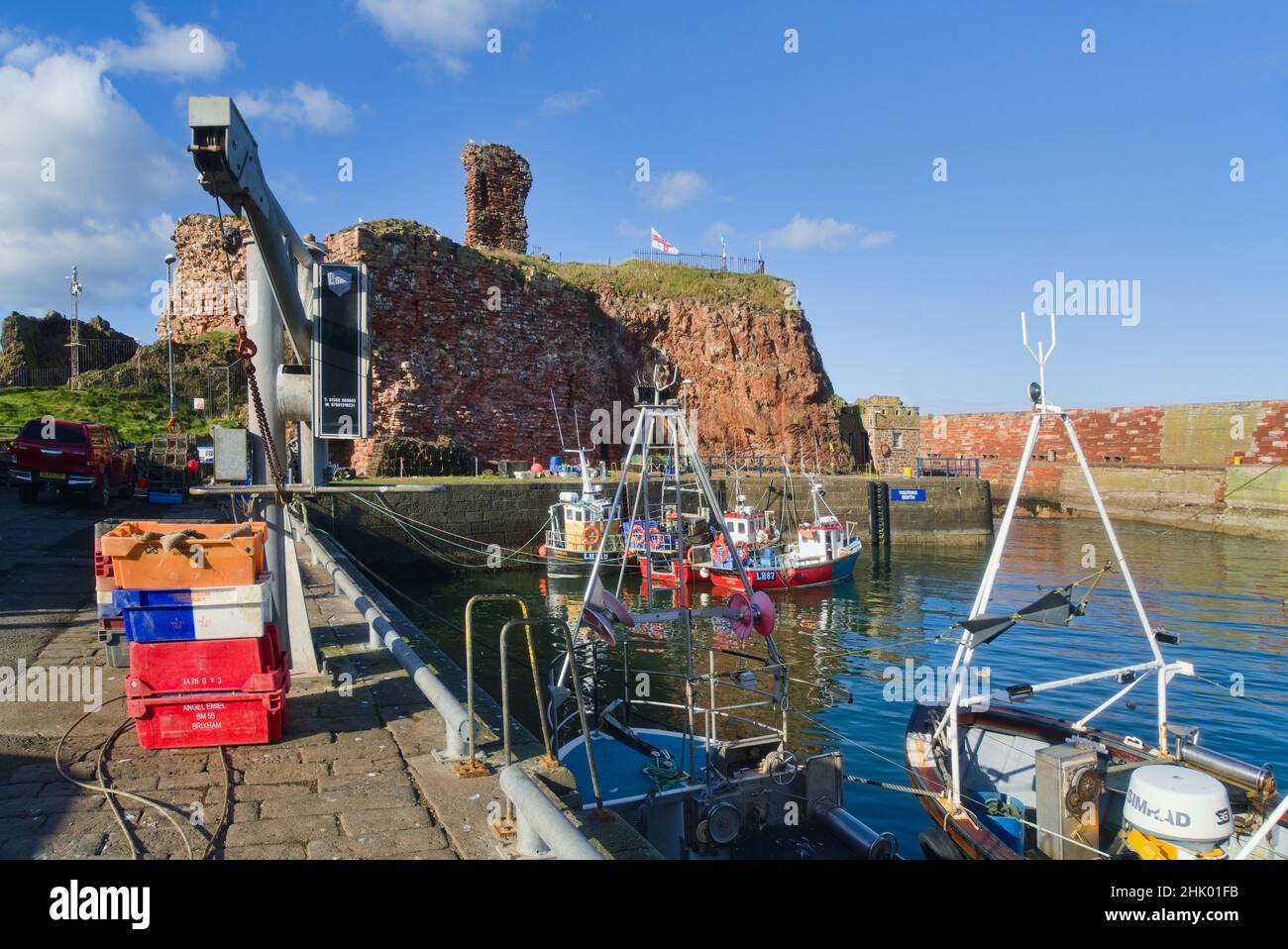 Looking west over Dunbar Harbour to ancient historic Castle ruins ...
