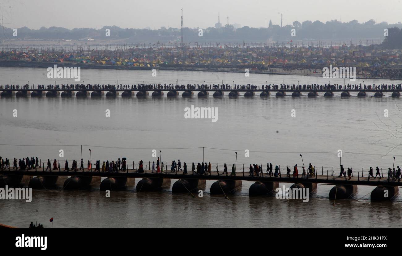 Devotees cross the River Ganges from a pontoon bridge during the ...