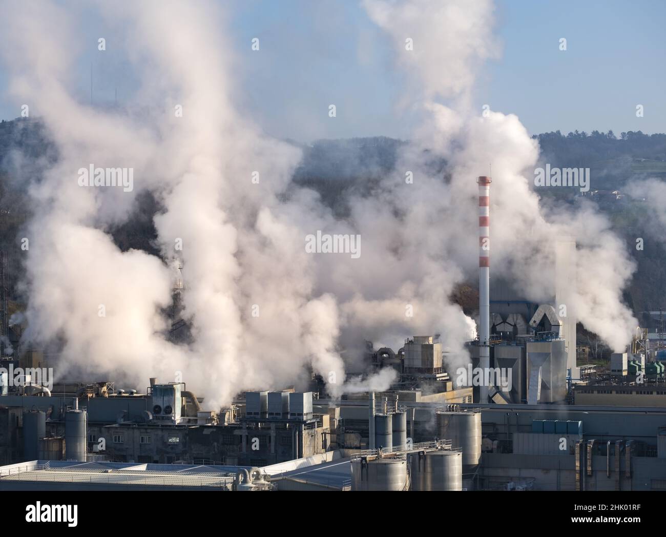 Fumes and pollution in factory chimneys Stock Photo - Alamy