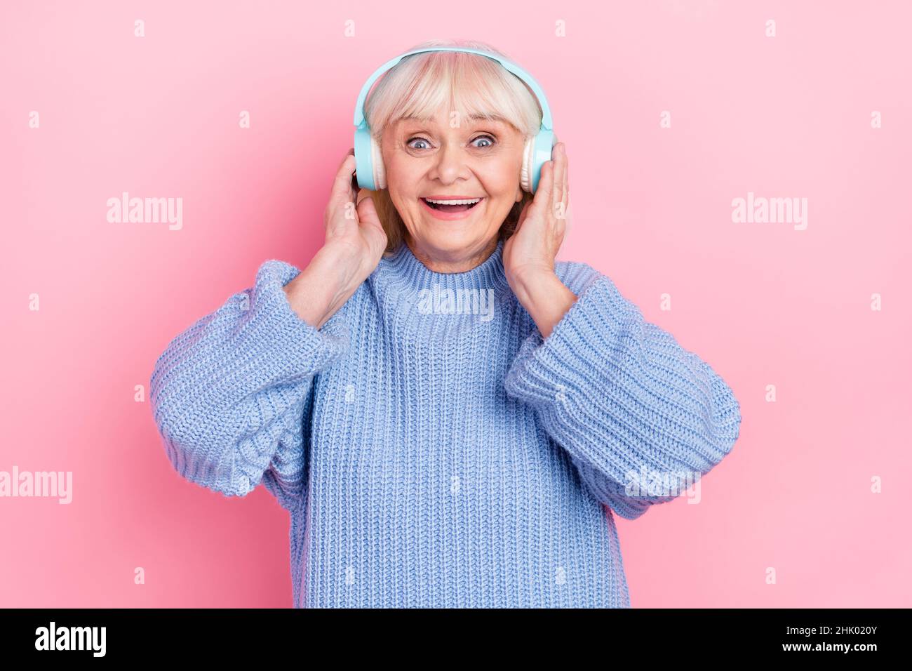 Portrait of attractive amazed cheerful grey-haired woman listening ...