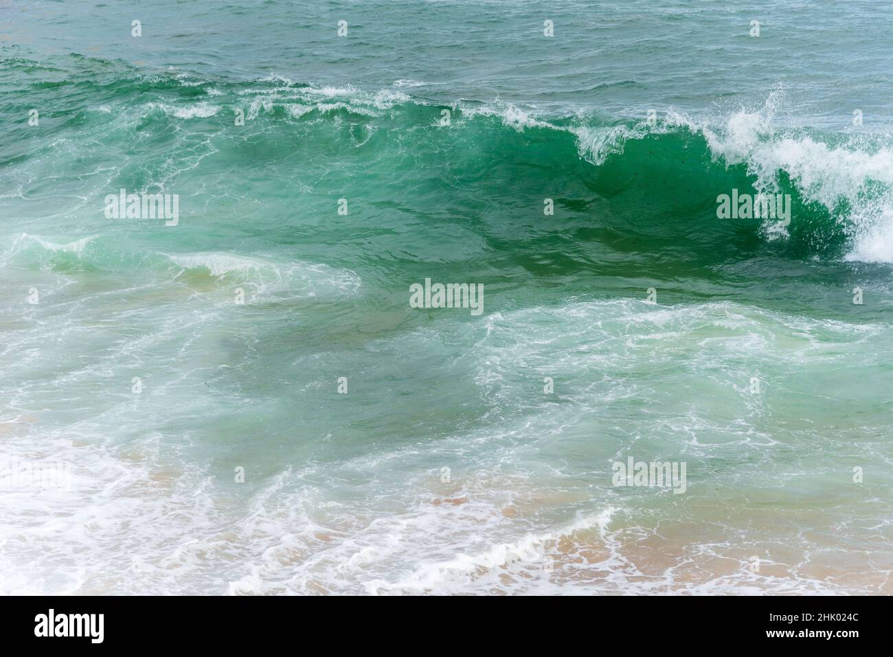 Ocean waves breaking on the sands of the famous Rio Vermelho beach ...