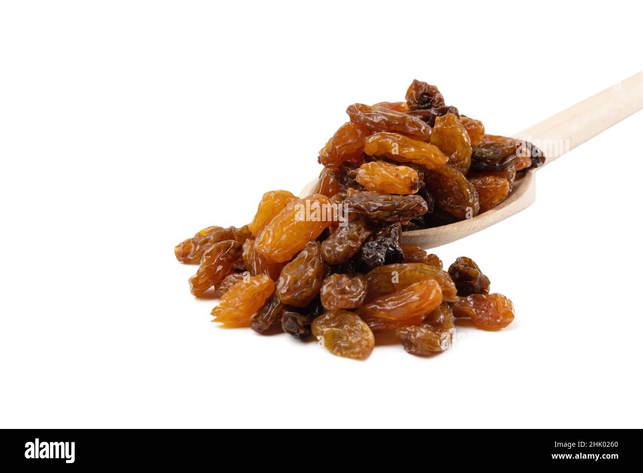 royal raisins on wooden spoon isolated on white background. Spice and ...