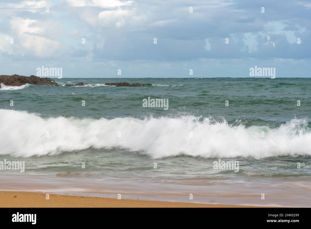 Ocean waves breaking on the sands of the famous Rio Vermelho beach ...