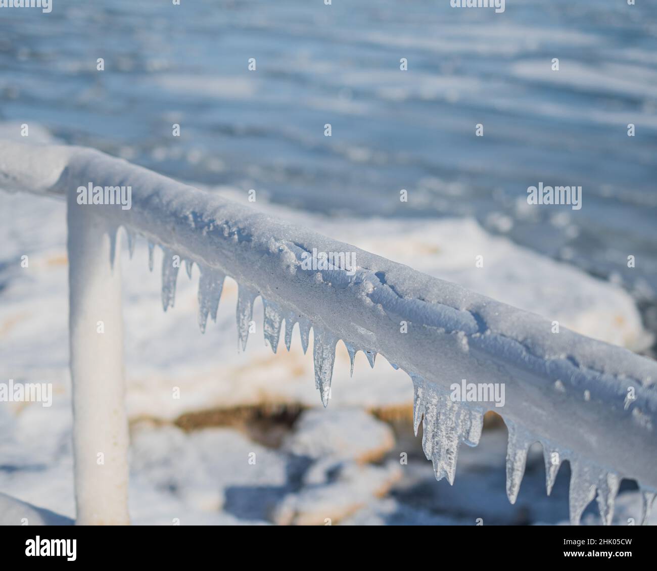 frozen metal railing with hanging ice Stock Photo - Alamy