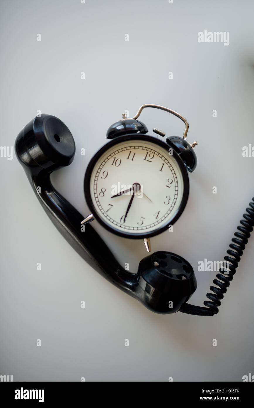 Old-fashioned clock and old phone handset from above Stock Photo - Alamy
