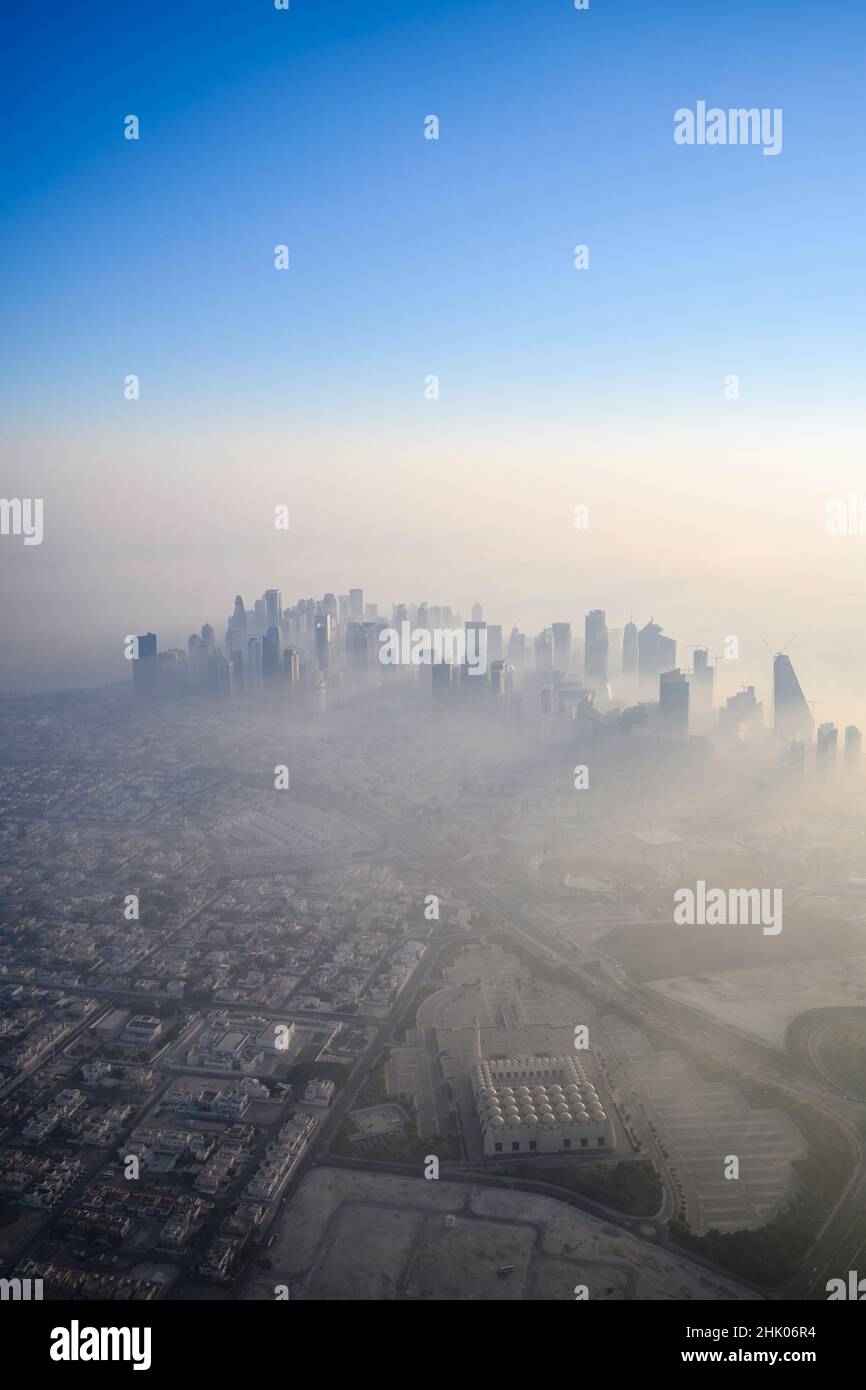 Doha skyline at sunrise with morning fog Stock Photo - Alamy